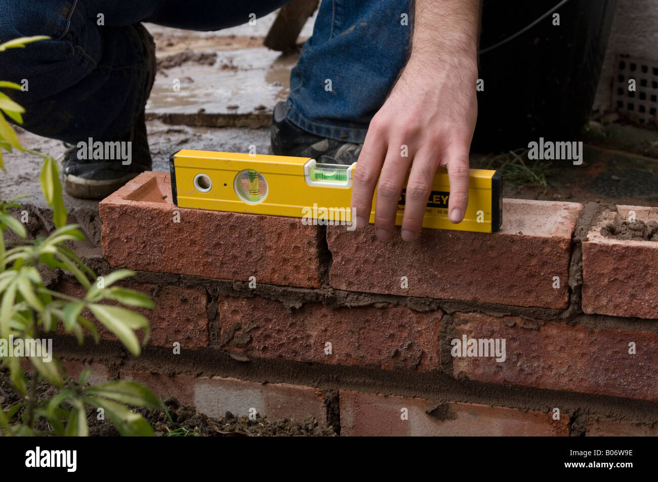 DIY How to build a brick wall Stock Photo - Alamy