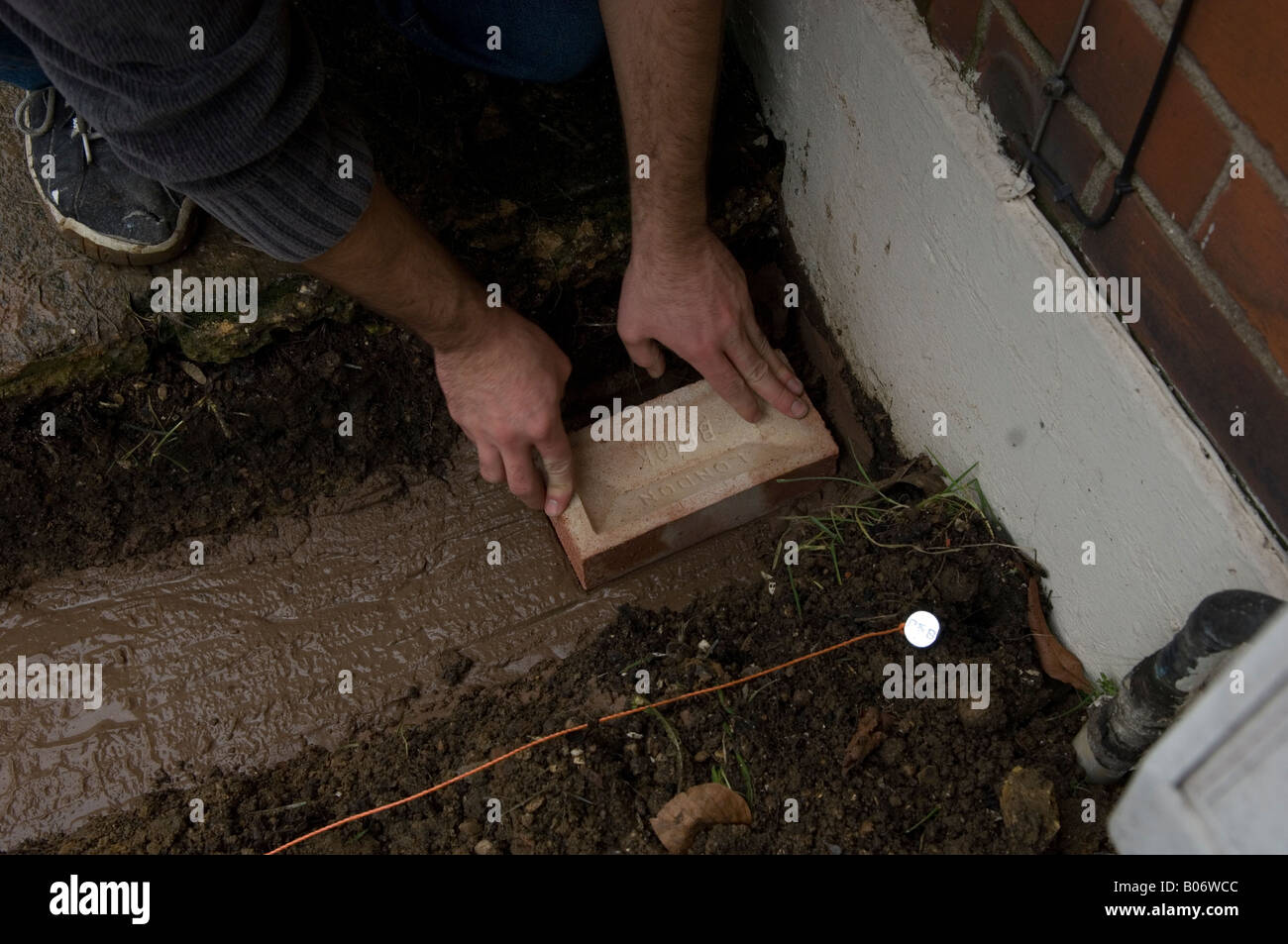 DIY How to build a brick wall Stock Photo - Alamy