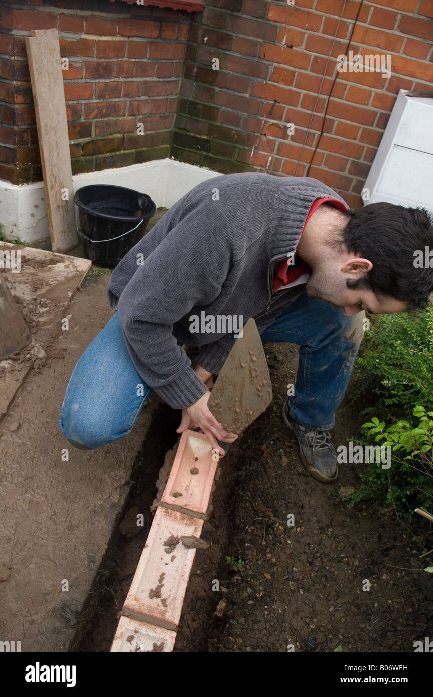 DIY How to build a brick wall Stock Photo - Alamy