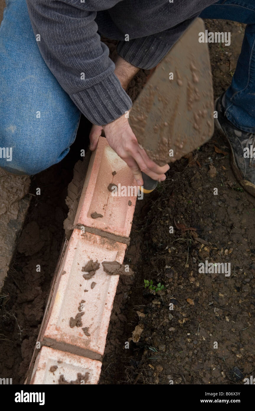 DIY How to build a brick wall Stock Photo - Alamy