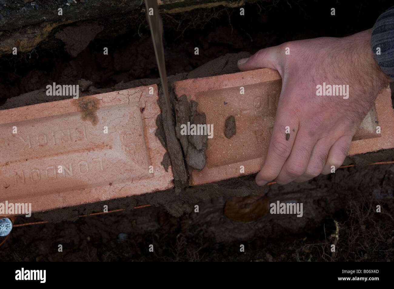 DIY How to build a brick wall Stock Photo - Alamy