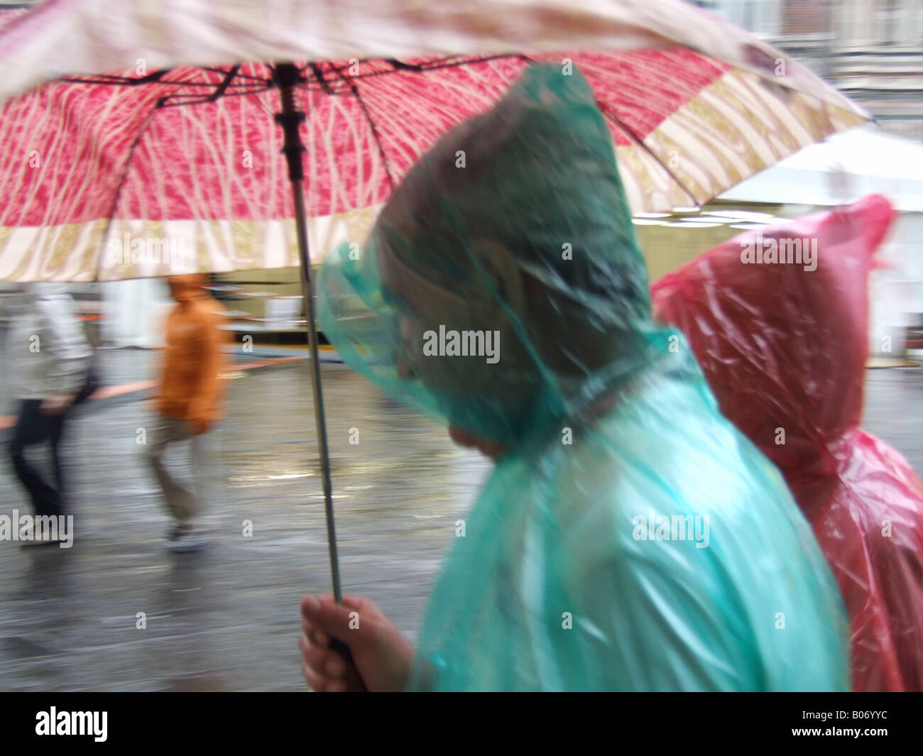 people with umbrella walking in rain in town Stock Photo - Alamy