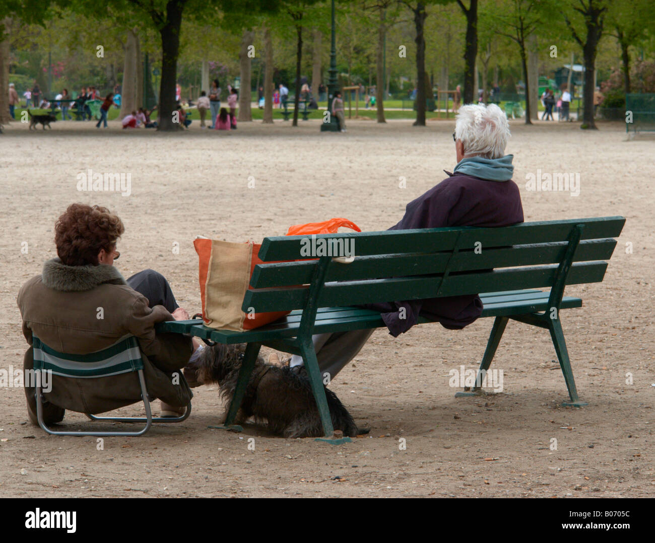 A couple with a dog resting at Place Joffre Paris France Stock Photo ...