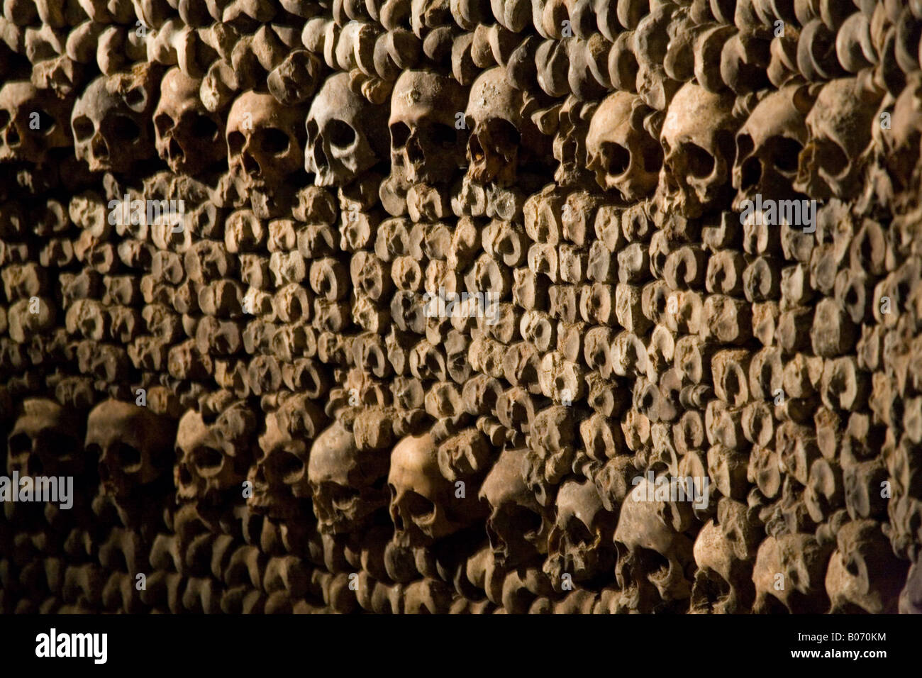 Human skulls and bones stacked in rows in the underground Catacombs ...