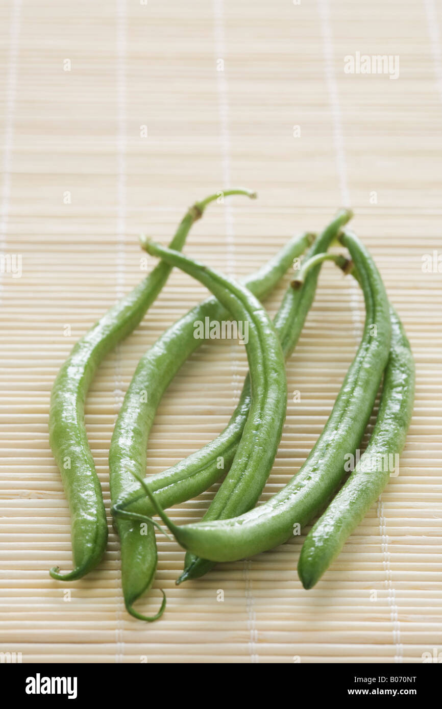 Green beens on light bamboo background Stock Photo - Alamy