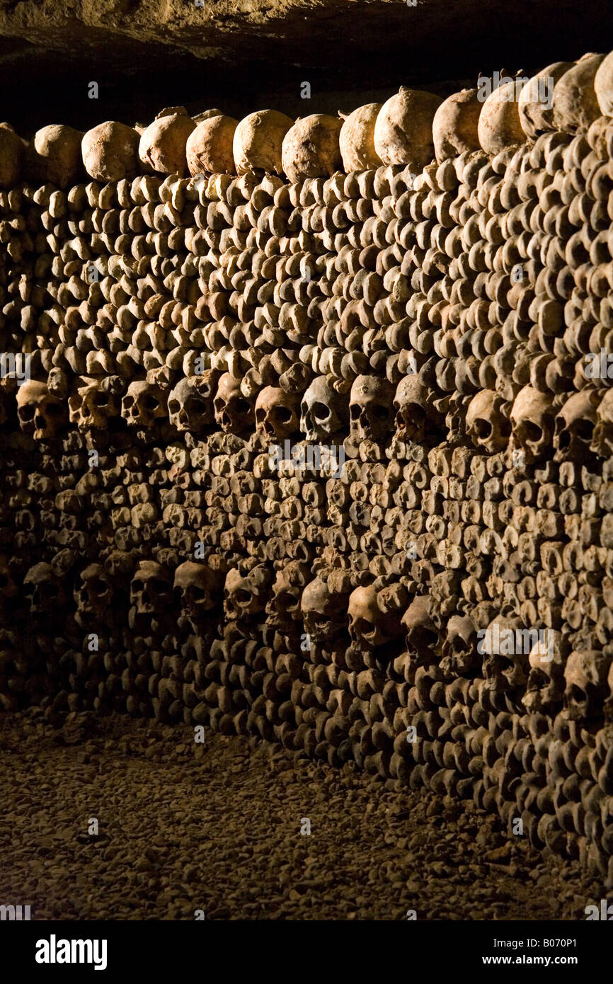 Human skulls and bones stacked in rows in the underground Catacombs ...