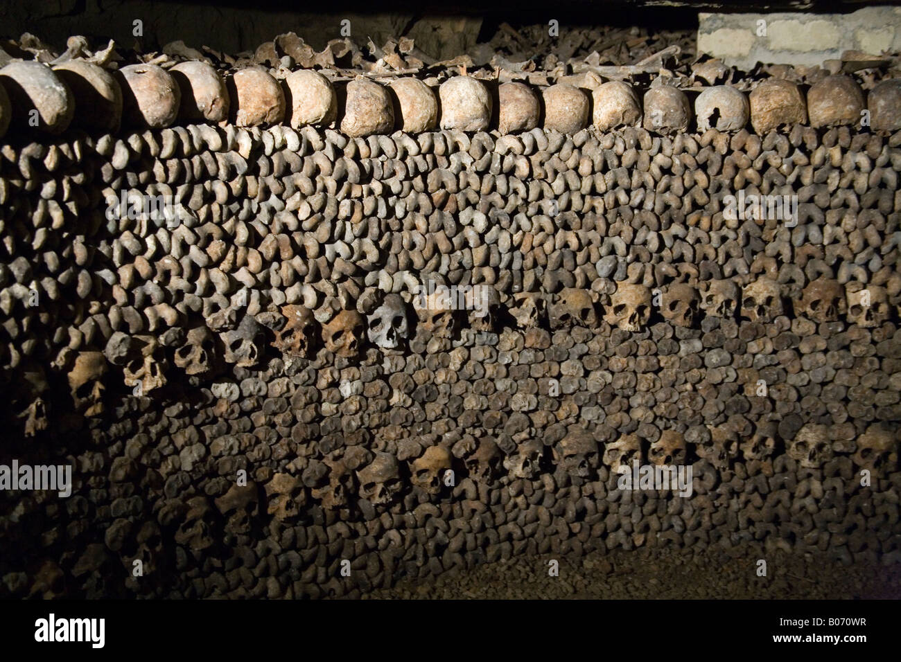Human skulls and bones stacked in rows in the underground Catacombs ...