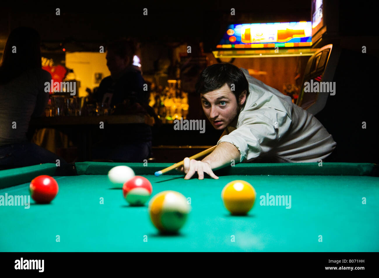 A patron takes aim during a round of 8-ball at the Knarr Tavern in ...