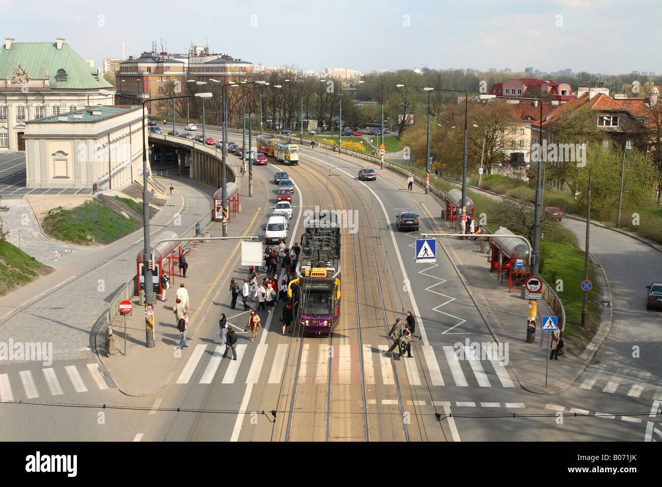 Warsaw Poland public transport trams commuters and pedestrians crossing ...