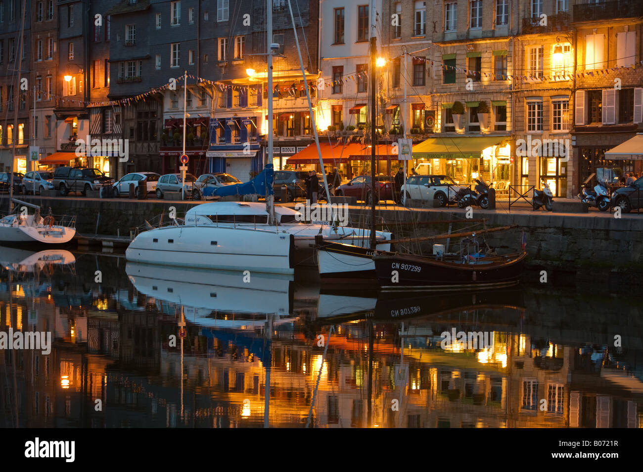 French harbour night time reflections of moored boats in the Honfluer ...