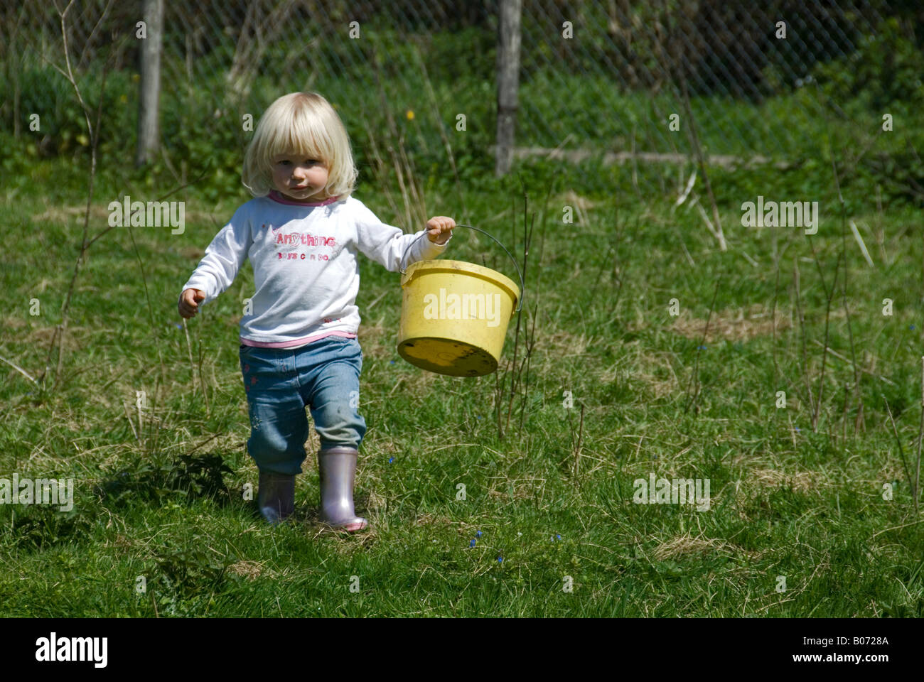 Stock photo of a little blond haired girl helping on the farm Stock ...