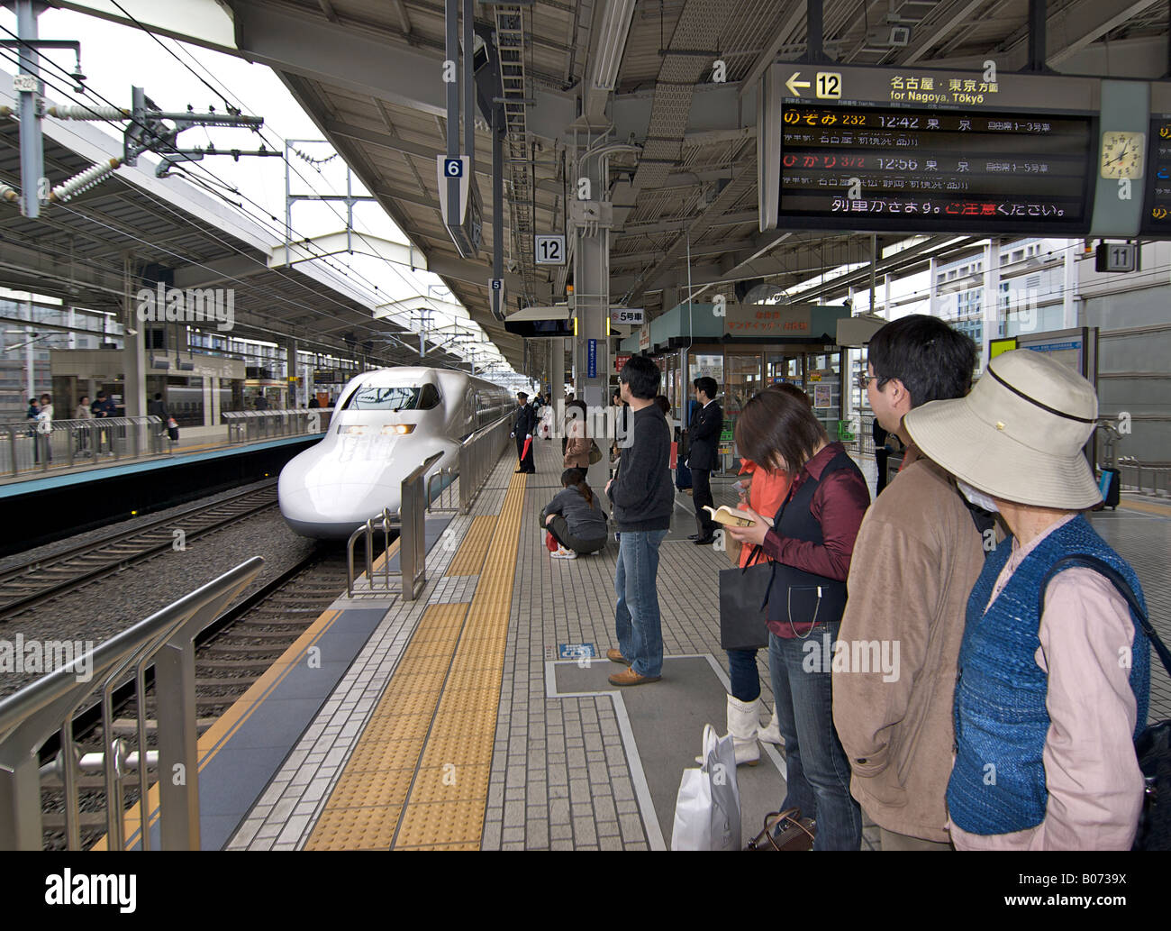 Passengers waiting board approaching shinkansen hi-res stock photography and images - Alamy