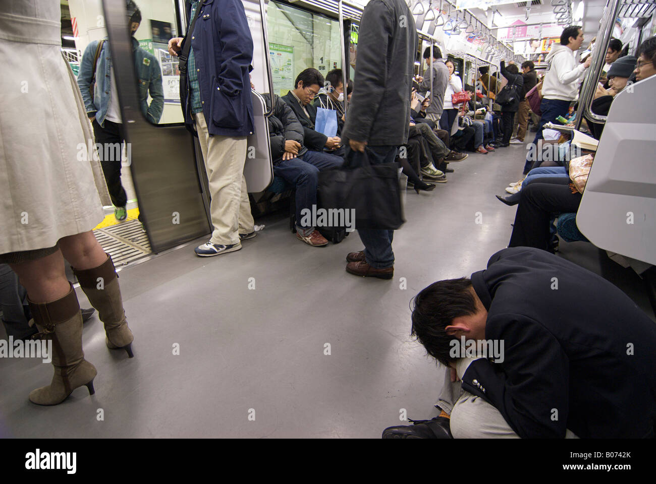 Late night subway train on the Tokyo Metro. Late night revelry has ...