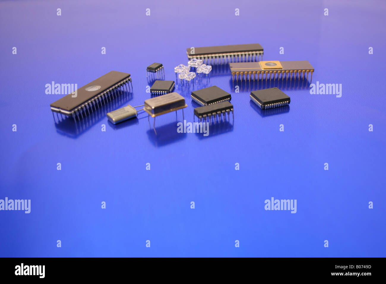 Various semiconductor chips, LEDs, and crystals on a blue background ...