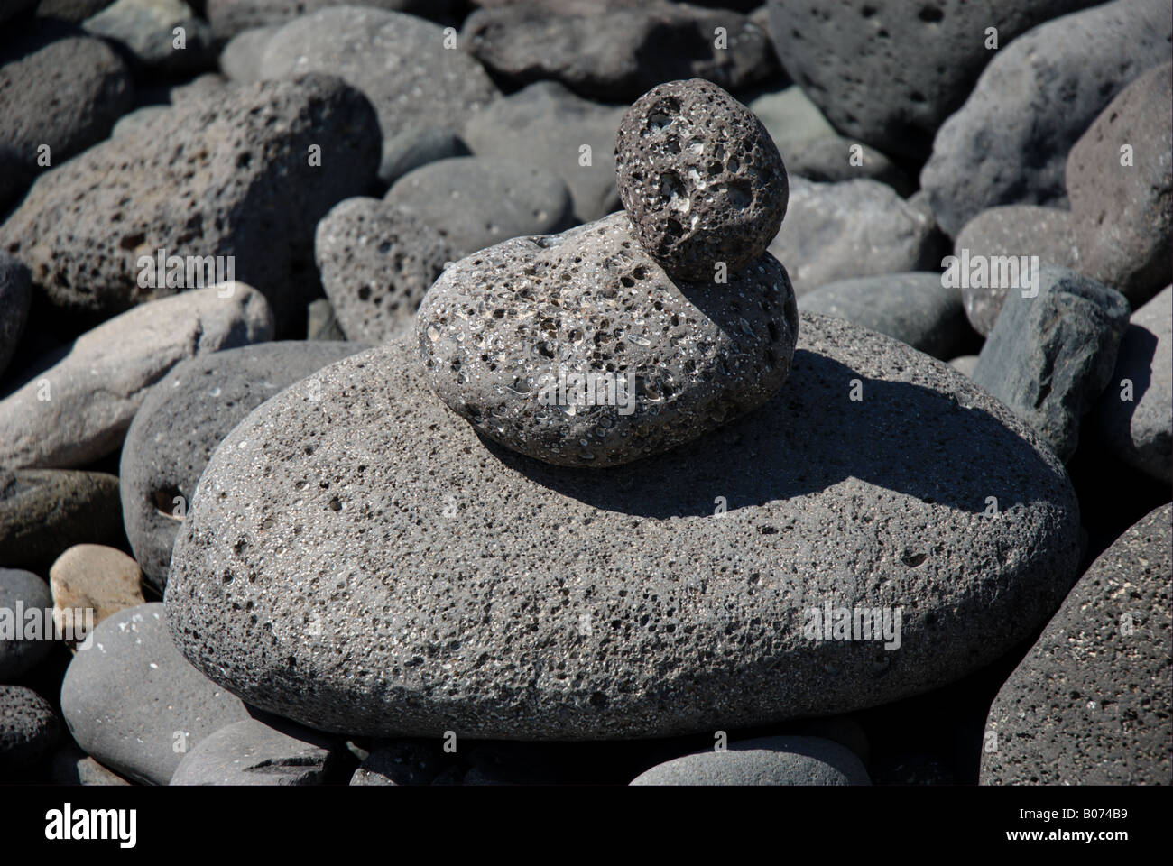 Pebbles of various sizes in a stack on a beach Stock Photo - Alamy