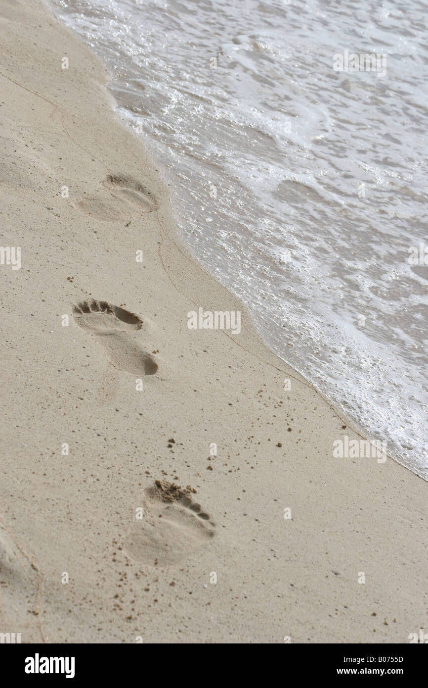 Two footprints into water Stock Photo - Alamy