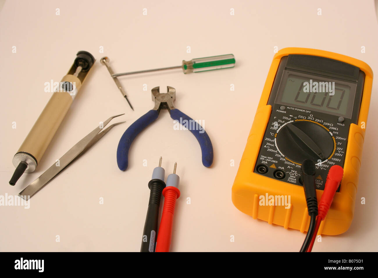 Typical electronics tools on white background: Multimeter, probes ...