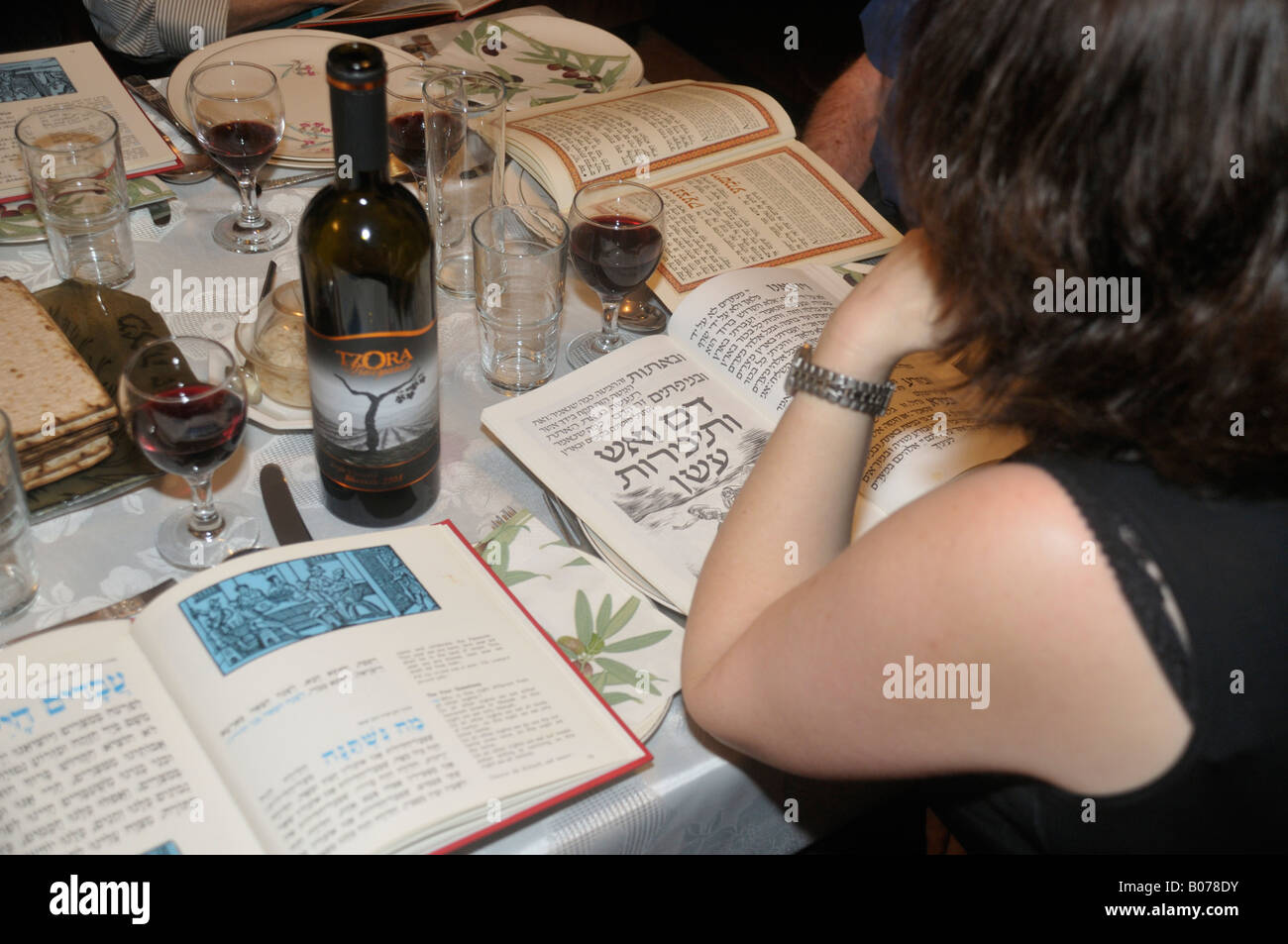 family sitting around a table set for a Jewish Festive meal on Passover ...