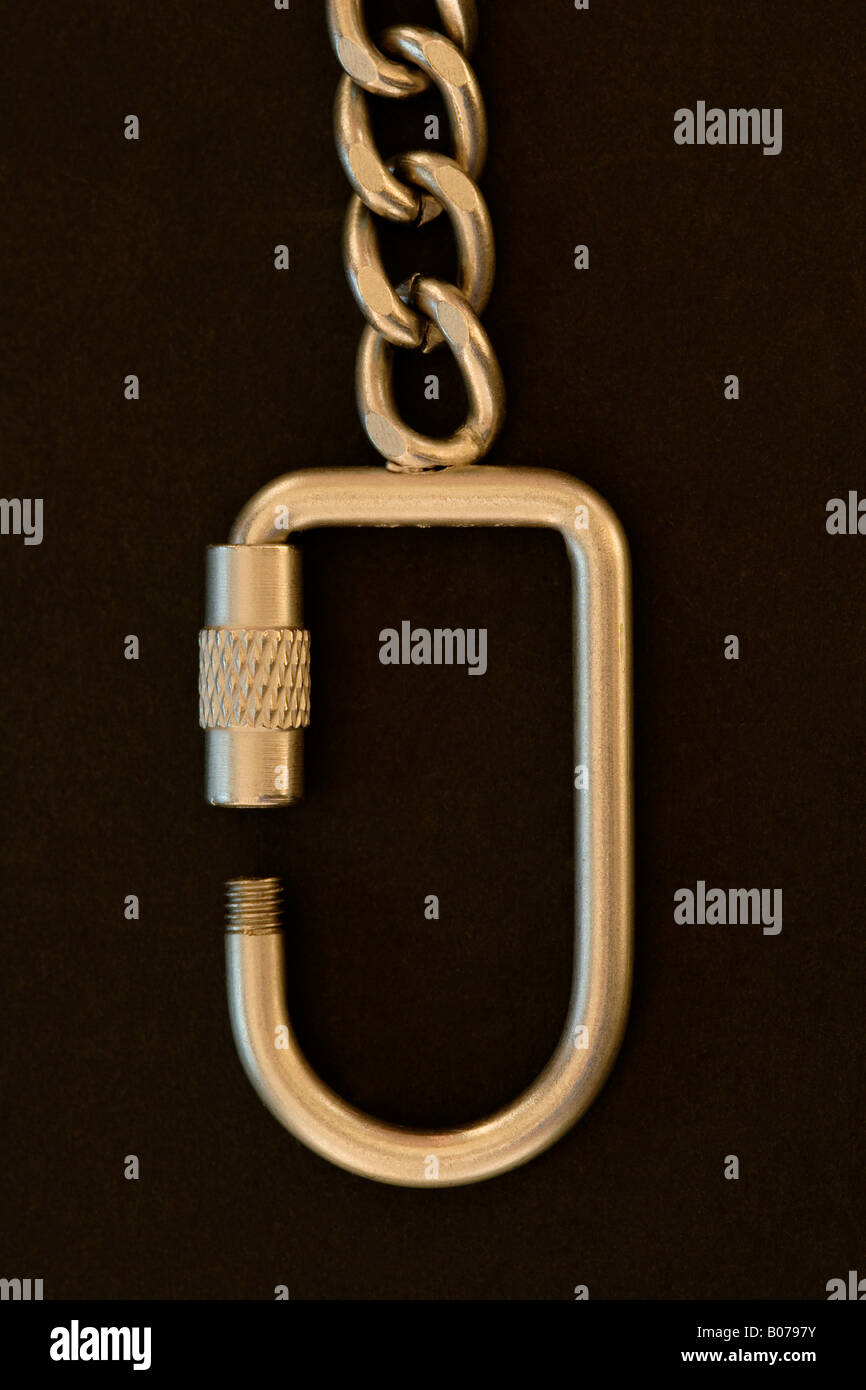 Silver keyring on chain close up Stock Photo - Alamy