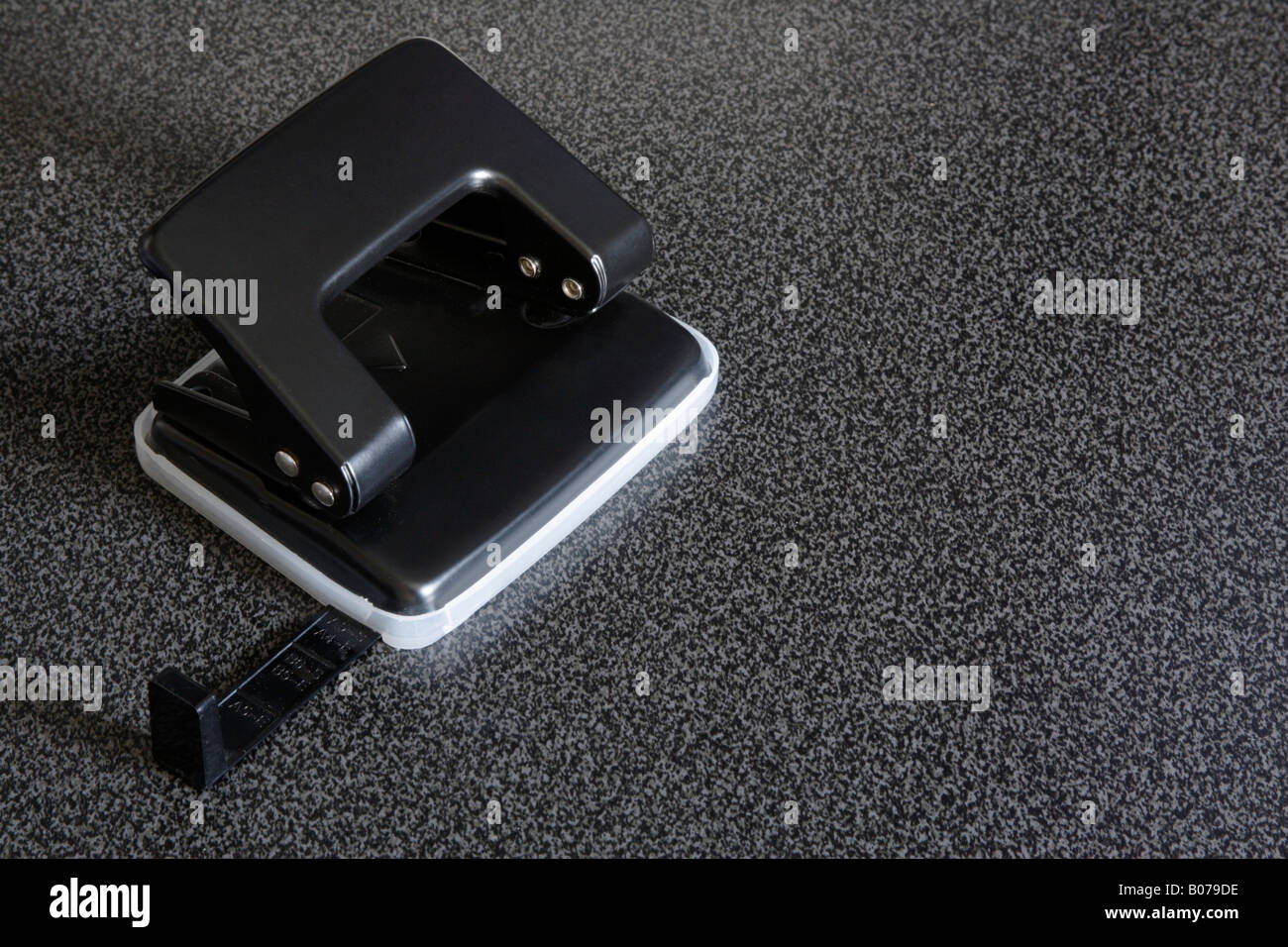 Hole puncher on desk close up Stock Photo - Alamy