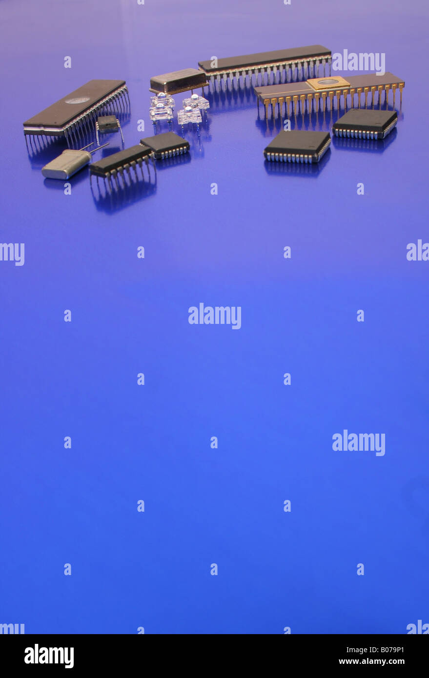Various semiconductor chips, LEDs, and crystals on a blue background ...