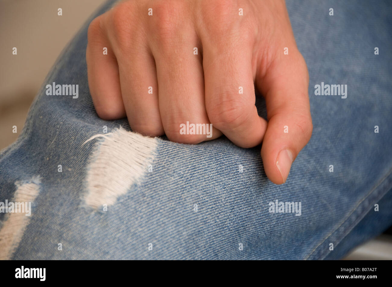 Young man wearing ripped blue Jeans Stock Photo - Alamy