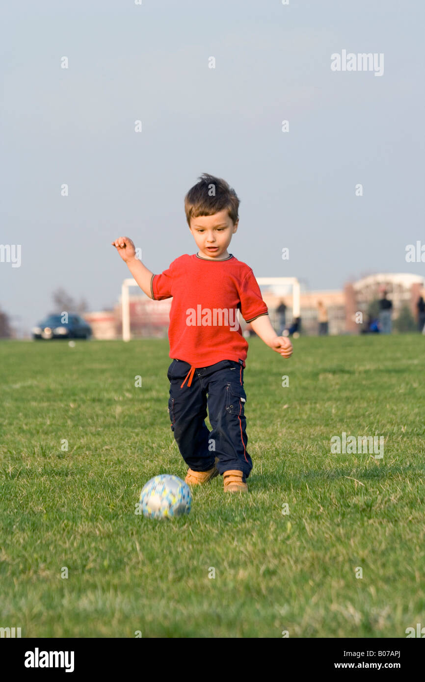 A boy is playing soccer Stock Photo - Alamy