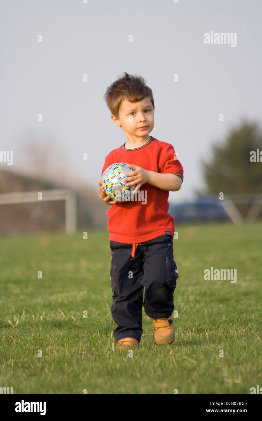 A boy is playing soccer Stock Photo - Alamy