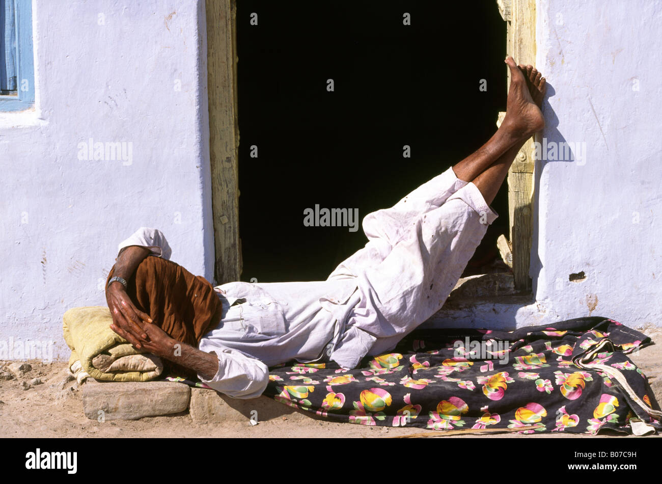 India Gujerat Rann of Kutch, Dhamadka Village man asleep in doorway ...
