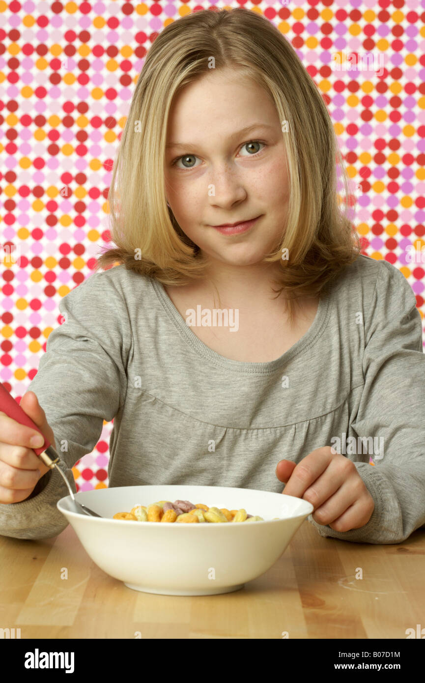 Girl eating cornflakes Stock Photo - Alamy