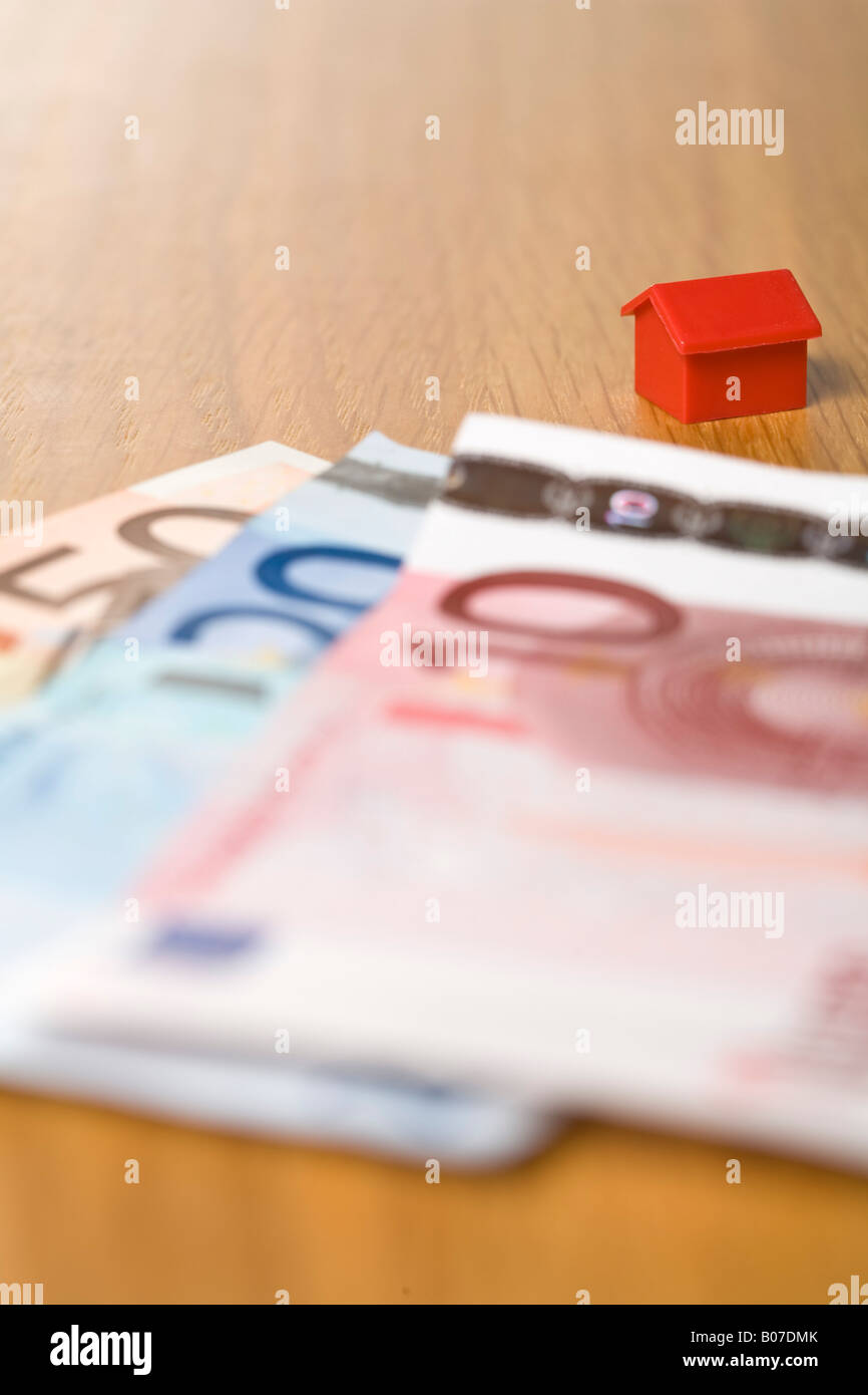 Toy house an bank notes Stock Photo - Alamy