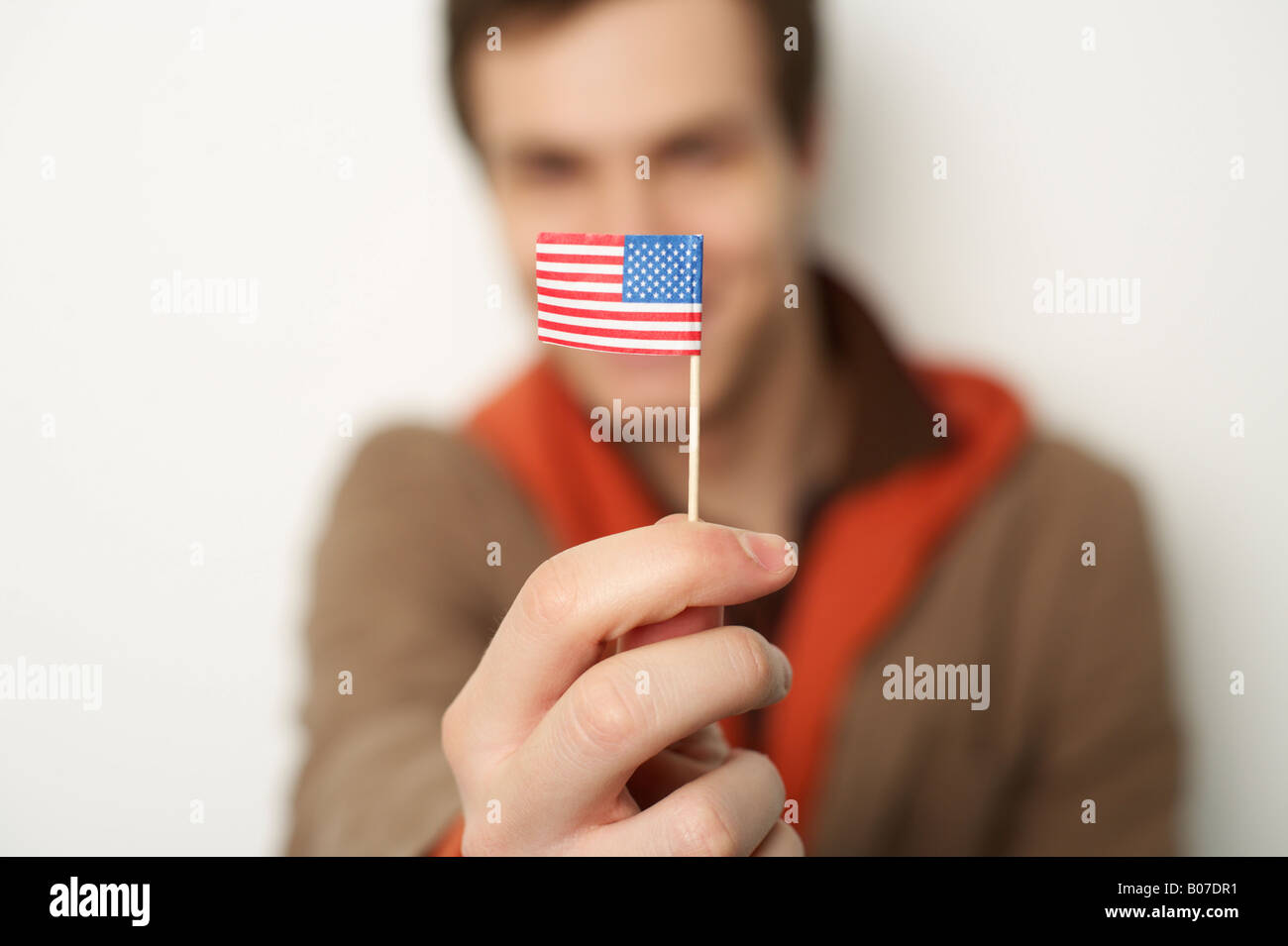 Young man with a small America Flag Stock Photo - Alamy