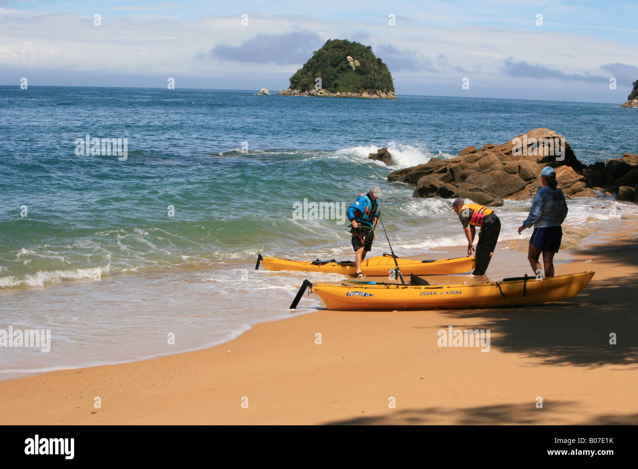 Kayaks coming ashore near split apple rock Stock Photo - Alamy
