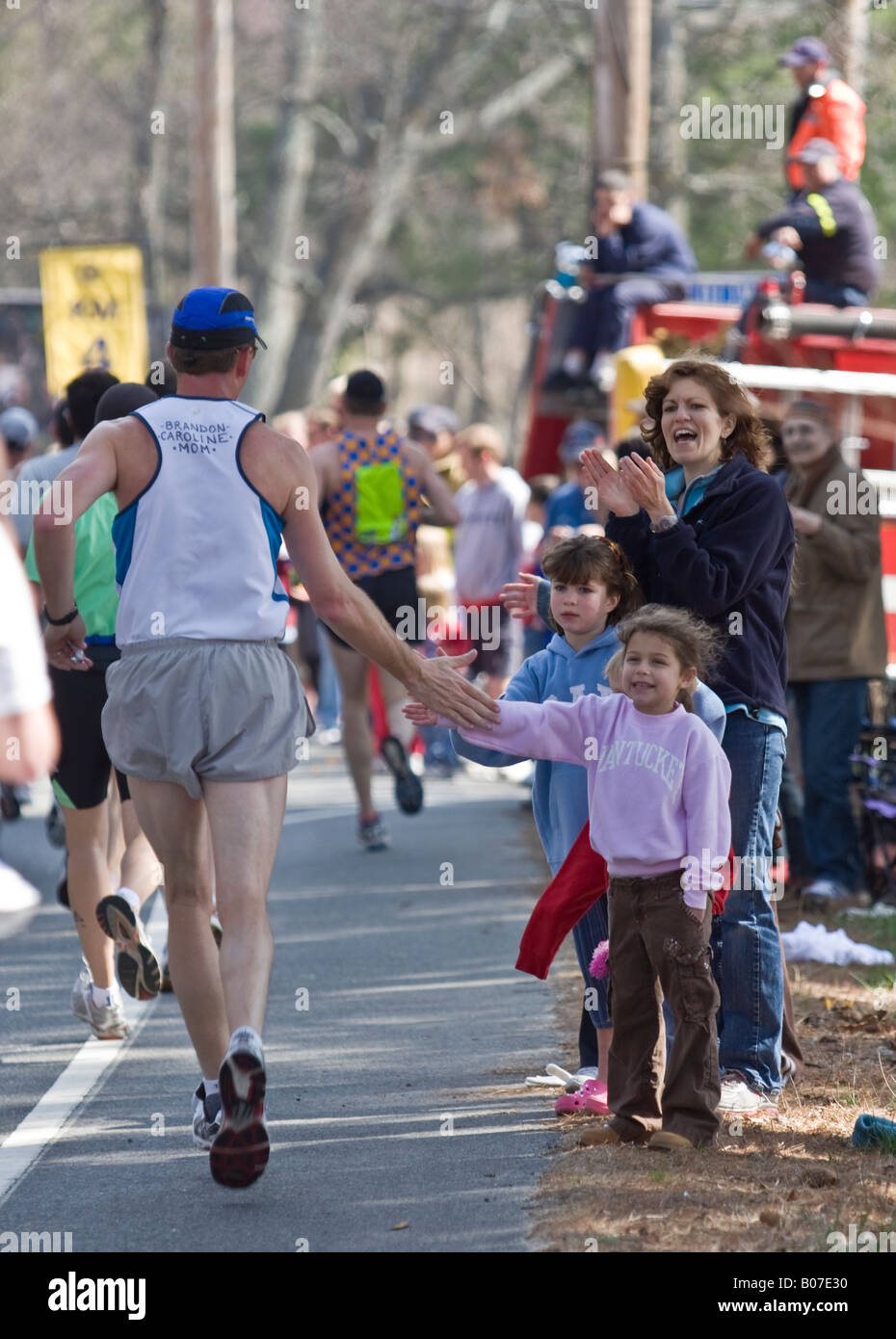 Children cheering Boston marathon racers Stock Photo - Alamy