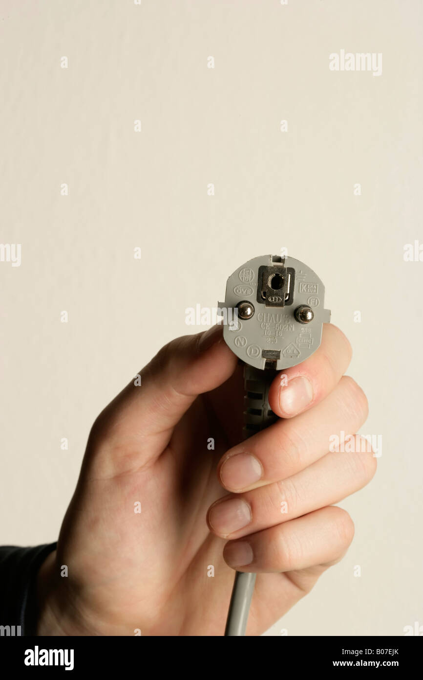 Man holding a plug Stock Photo - Alamy