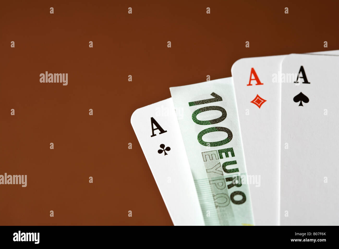 Playing cards with bank note in between Stock Photo - Alamy