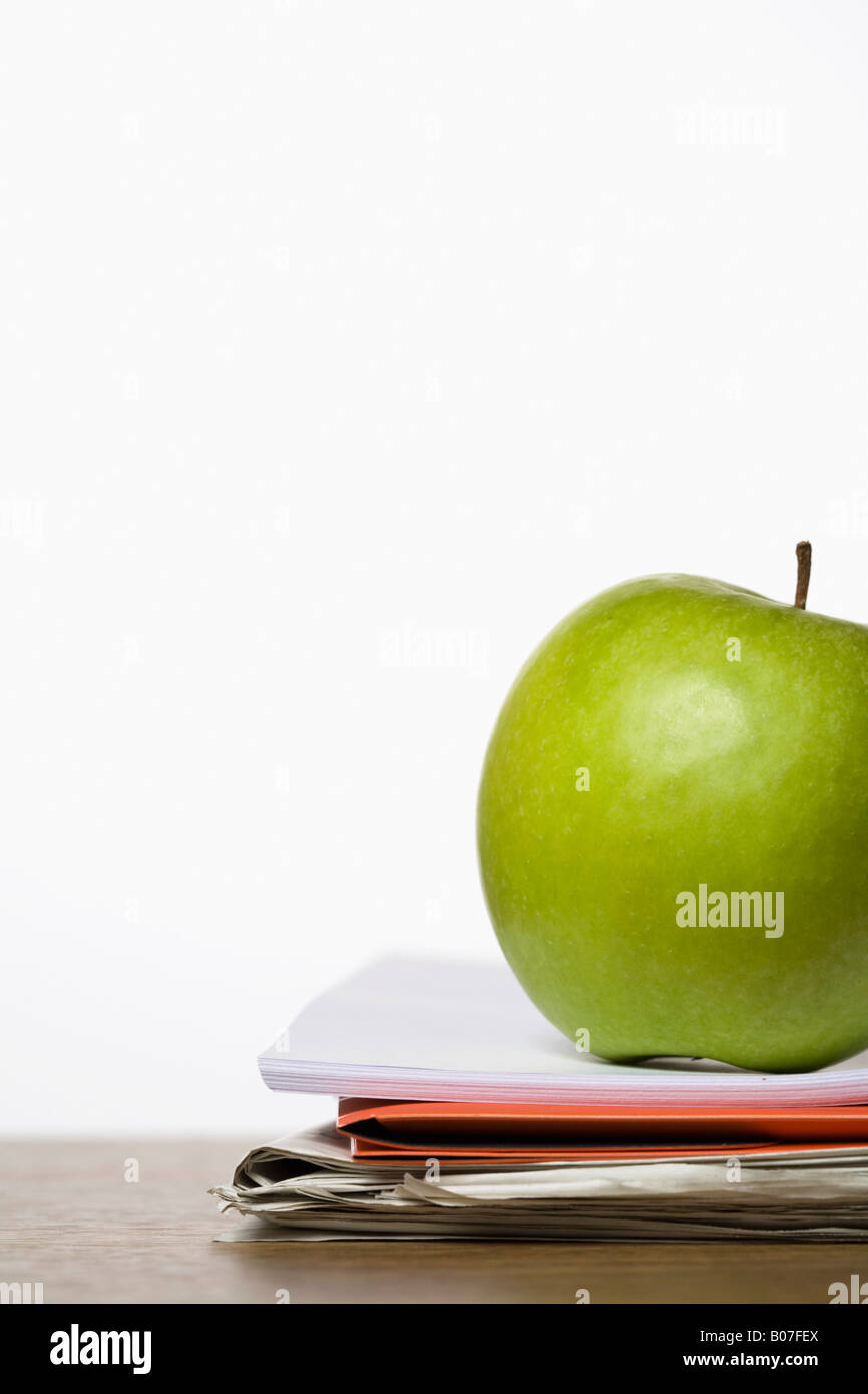Apple on documents Stock Photo - Alamy