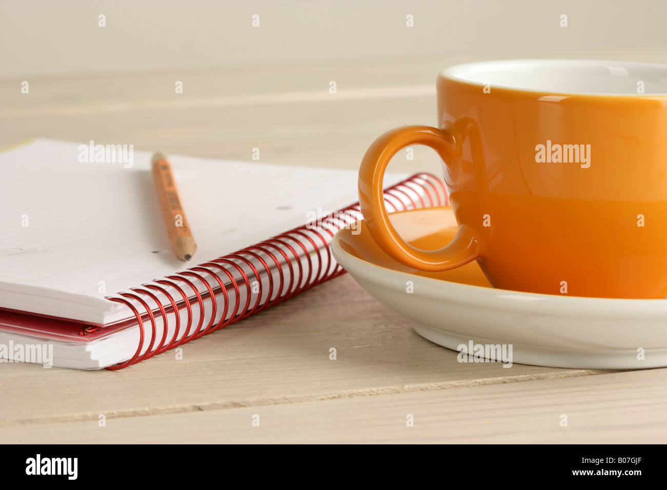 Cup of coffee, pencil and a writing pad on a table Stock Photo - Alamy