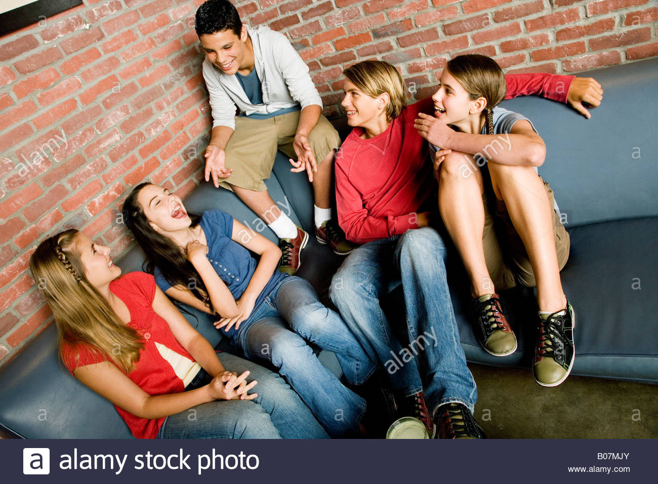 Group of teenage friends at a bowling alley, laughing and joking Stock ...