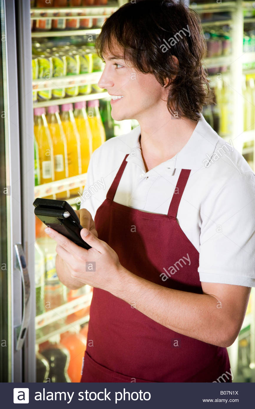 Shop assistant stocktaking in a supermarket Stock Photo, Royalty Free ...
