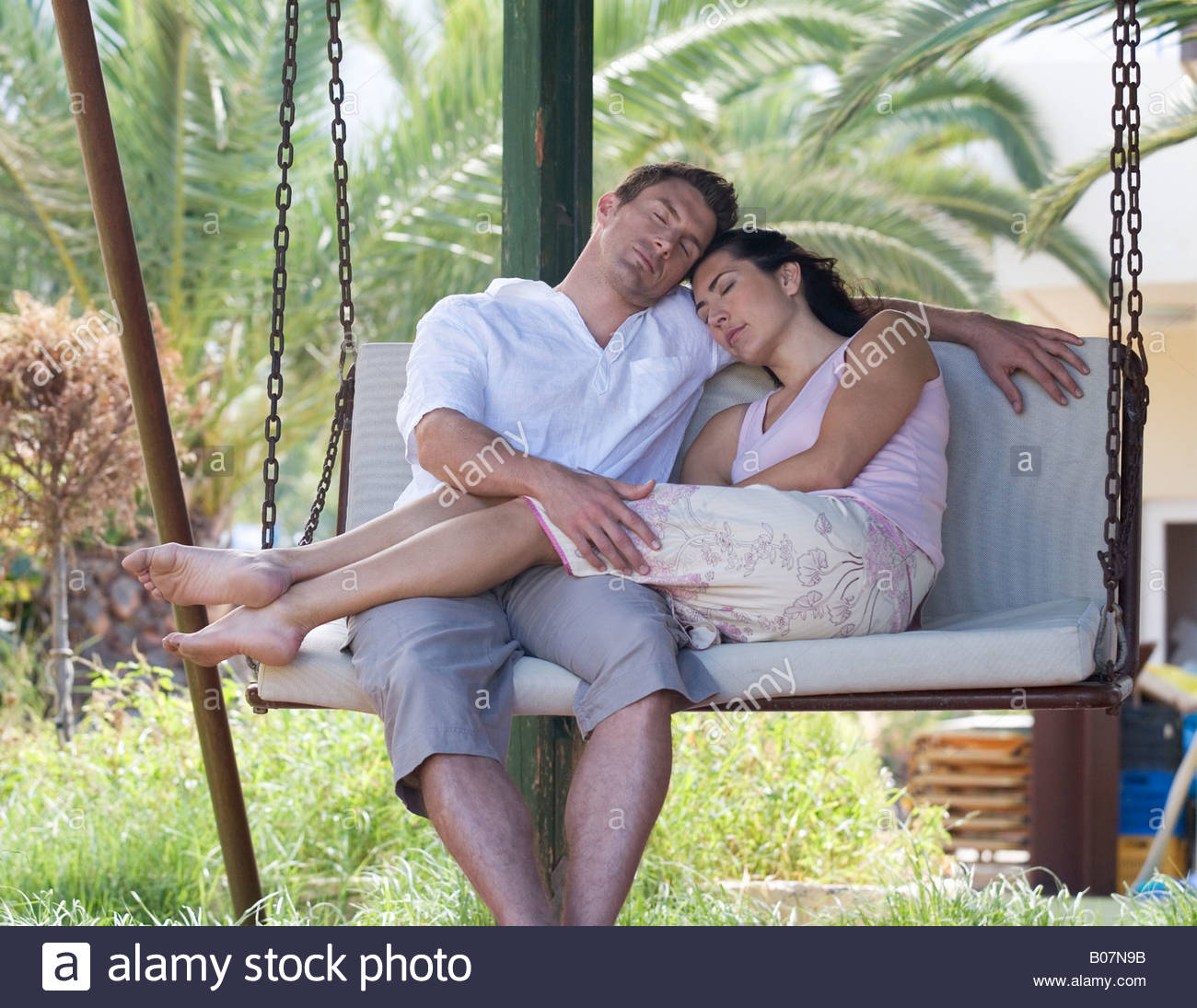 Couple Relaxing On Swing Stock Photos & Couple Relaxing On Swing Stock ...