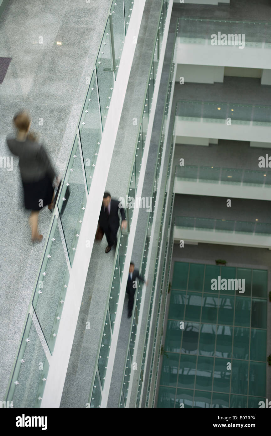 Businesspeople walking through office building Stock Photo - Alamy