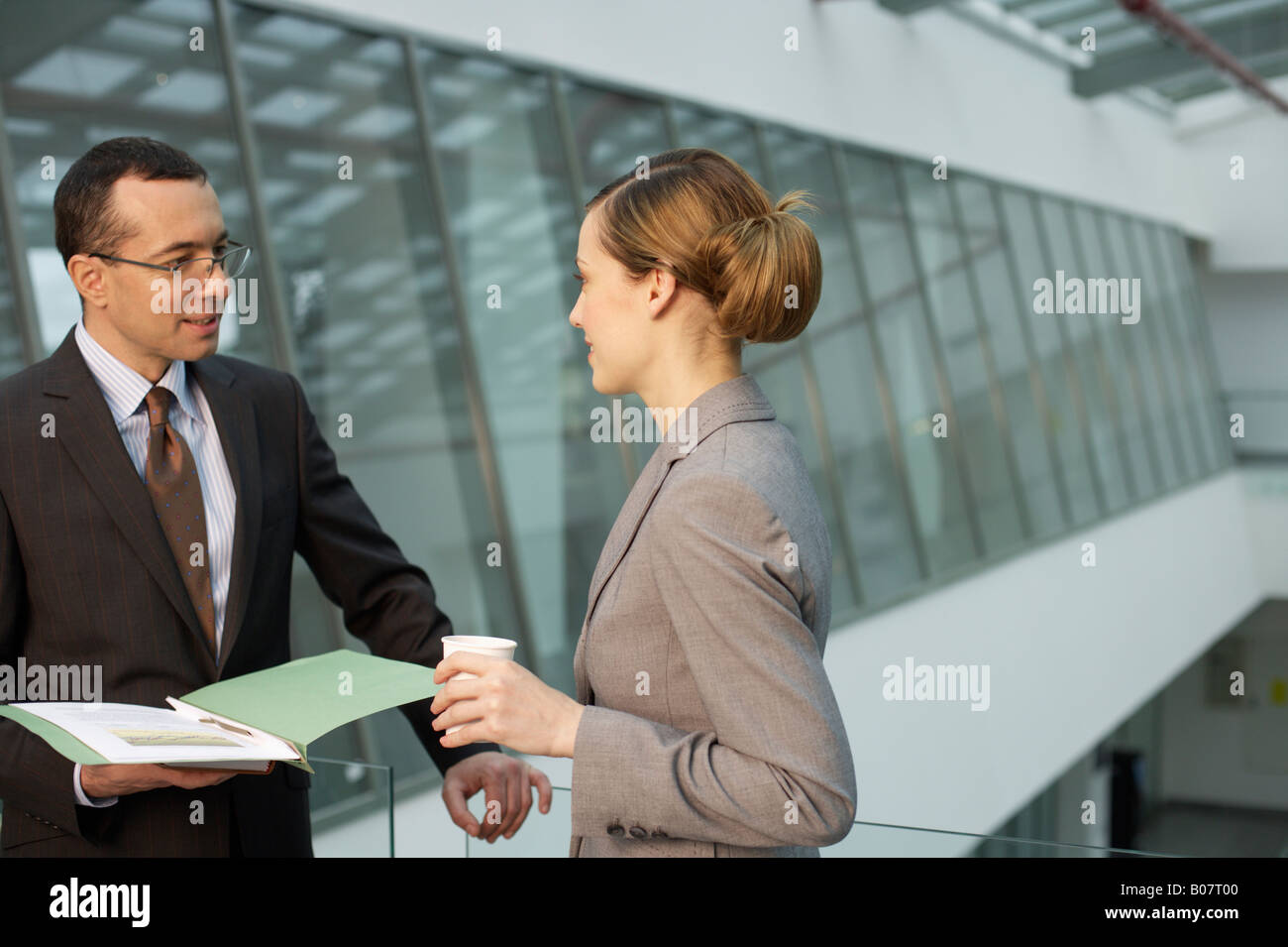Two businesspeople talking Stock Photo - Alamy Two businesspeople talking Stock Photo - Alamy