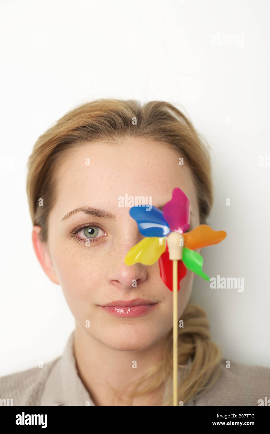 Young woman with a windmill in front of her face Stock Photo - Alamy