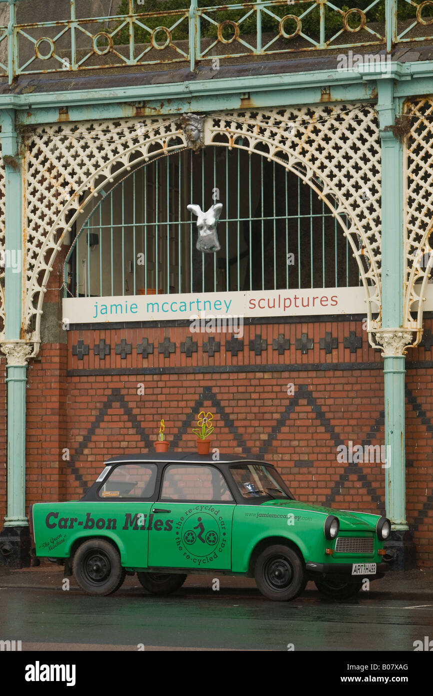 A green East German Trabant modified as a pedal car parked on the road ...
