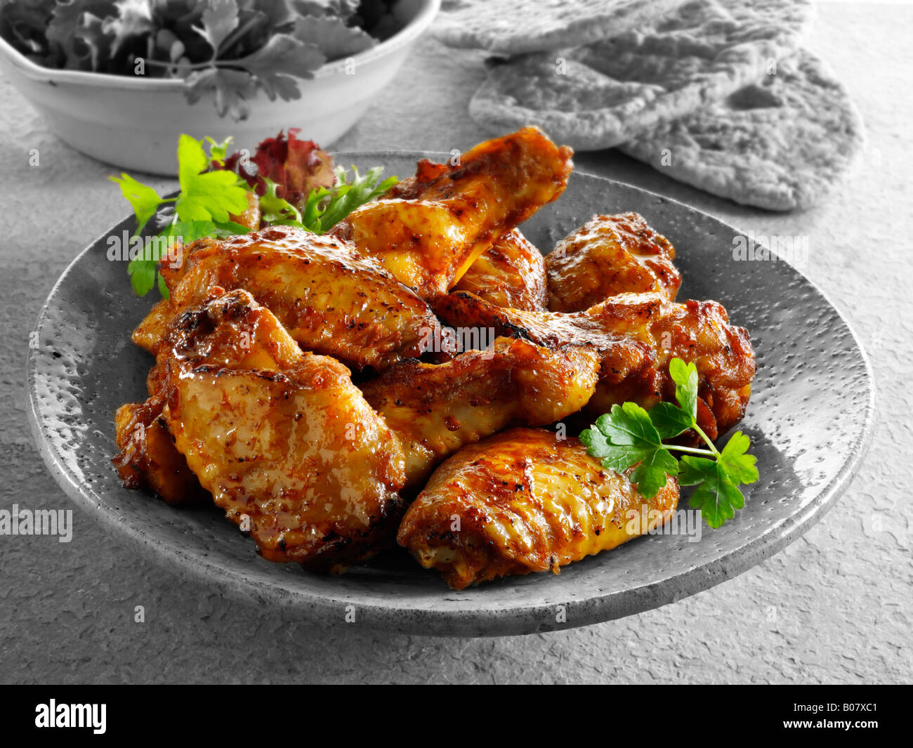 Barbeque (BBQ) Chicken wings served on a plate in a table setting Stock ...