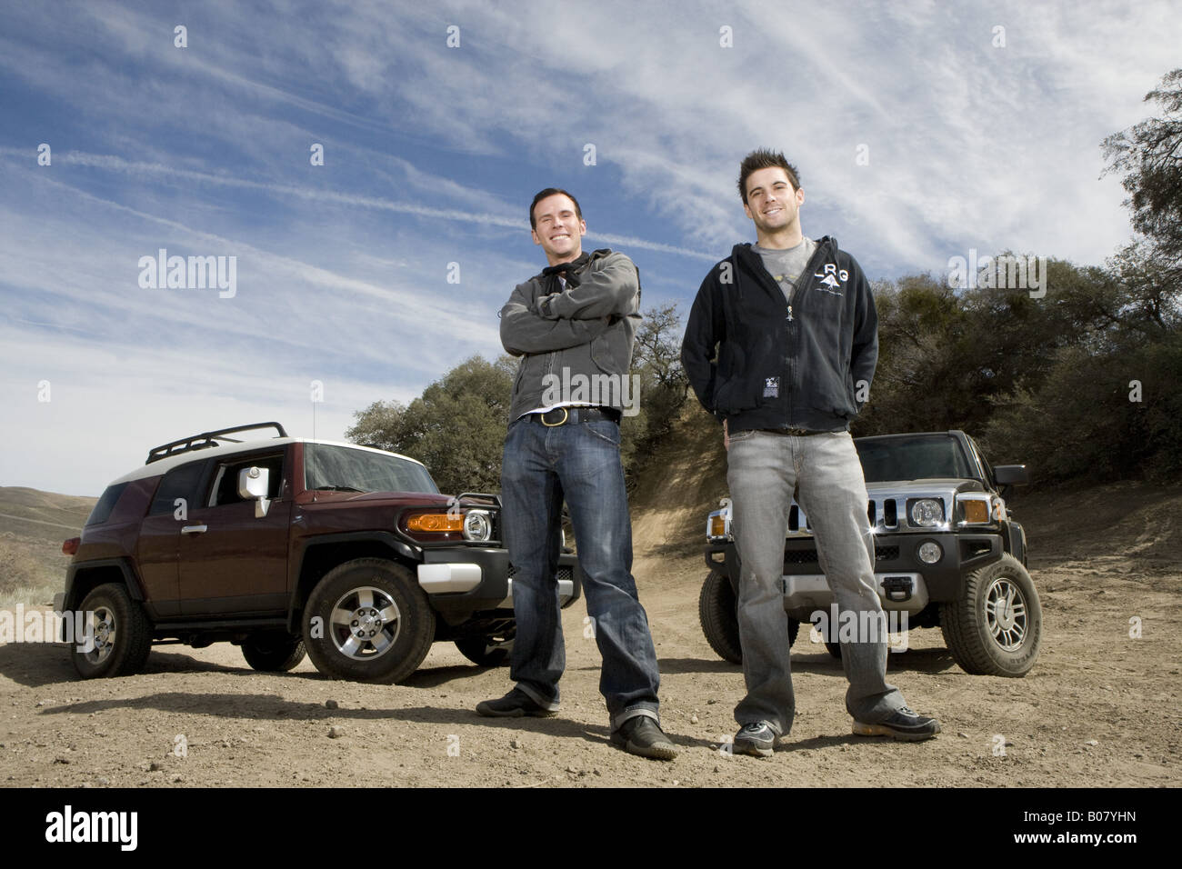Two men stand by their off-road vehicles smiling Stock Photo - Alamy
