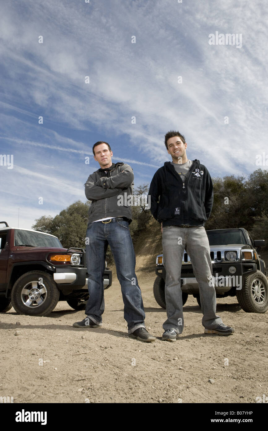 Two men stand by their off-road vehicles smiling Stock Photo - Alamy