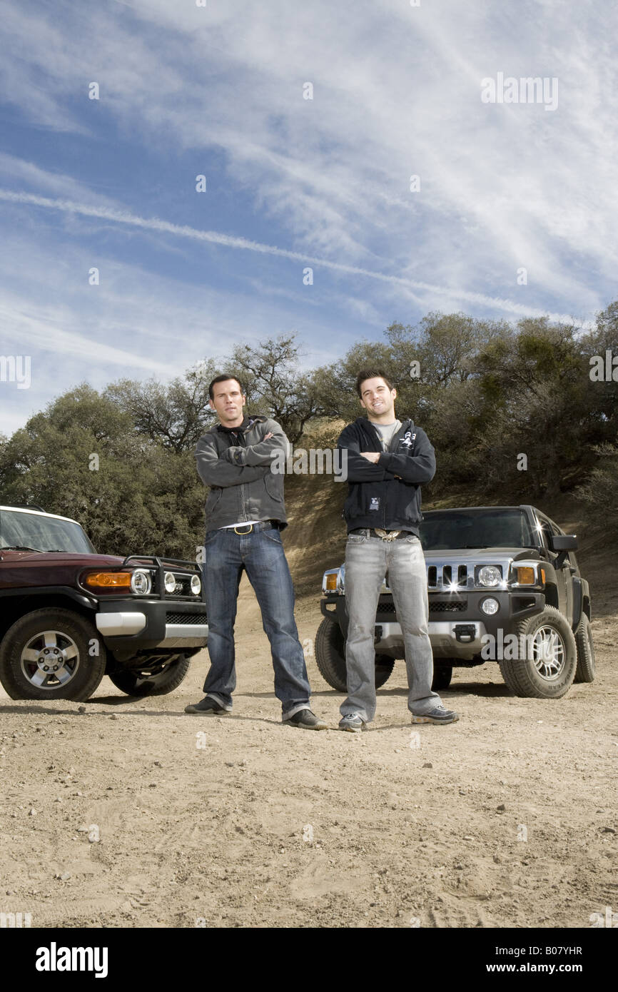 Two men stand by their off-road vehicles smiling Stock Photo - Alamy
