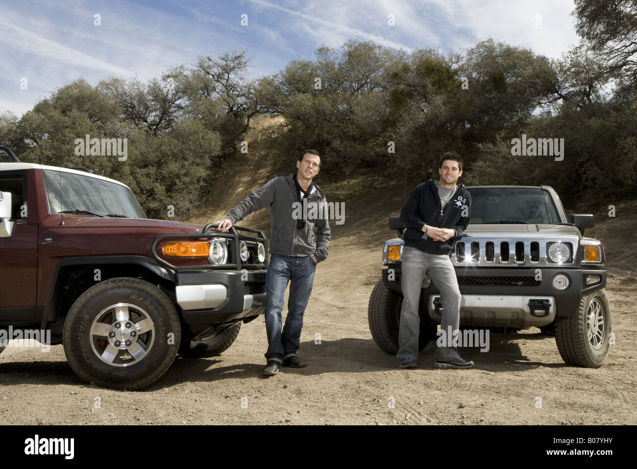 Two men lean against their off-road vehicles Stock Photo - Alamy
